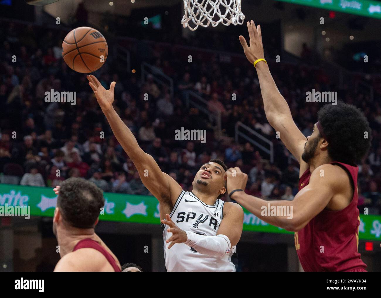 San Antonio Spurs' Keldon Johnson, left, shoots over Cleveland ...