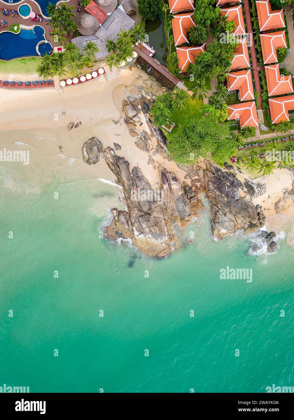 Top down aerial view of a tourist resort and sandy beach with shallow ...