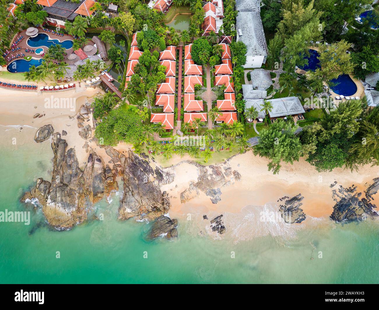 Top down aerial view of a tourist resort and sandy beach with shallow ...