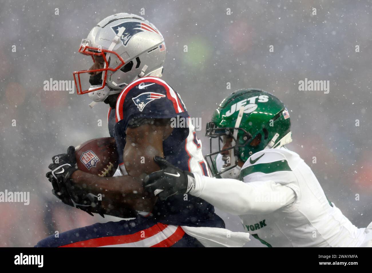 New England Patriots wide receiver Jalen Reagor, left, hauls in a pass ...