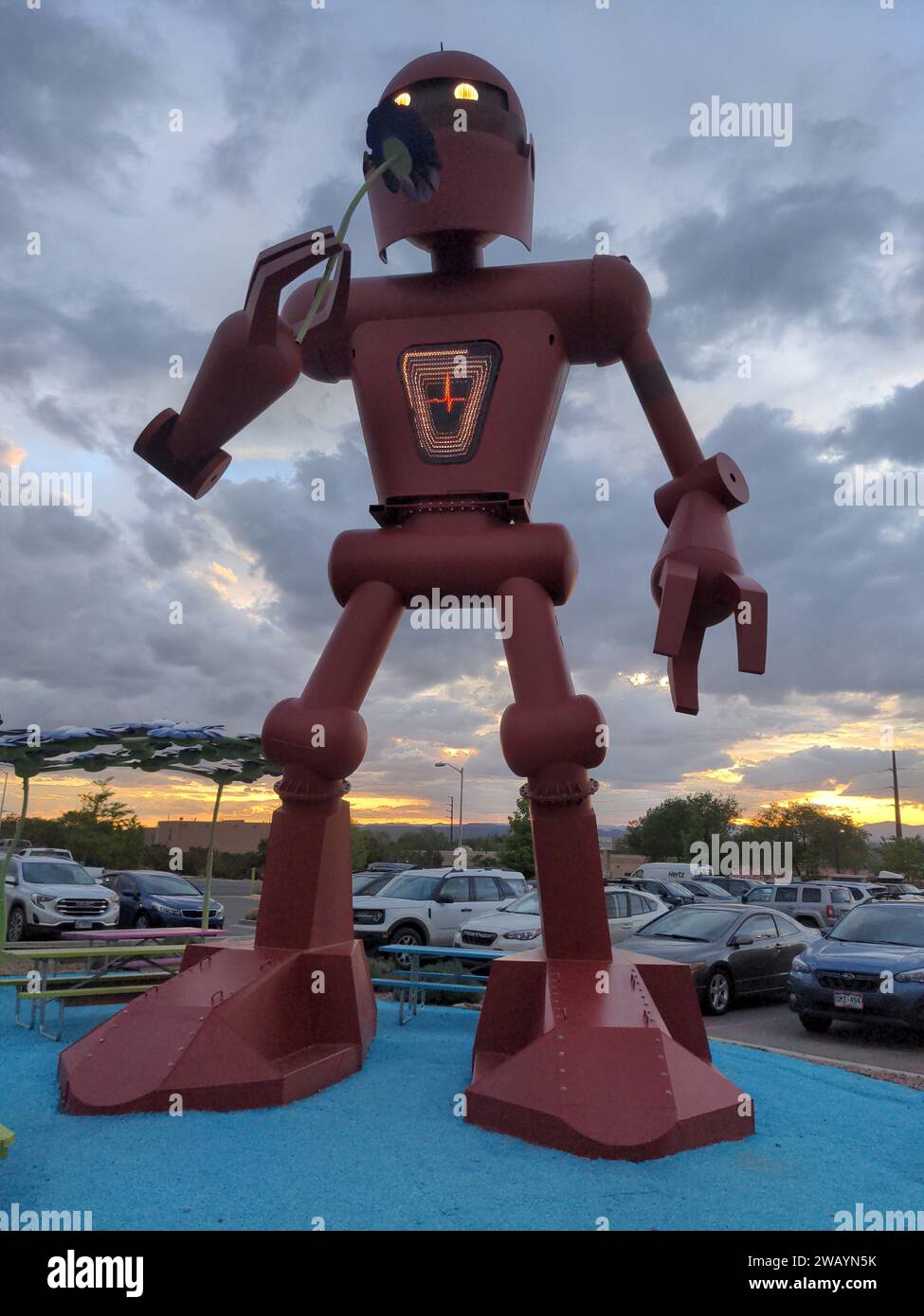 An industrial robotic arm is mounted on a concrete parking lot lot in ...