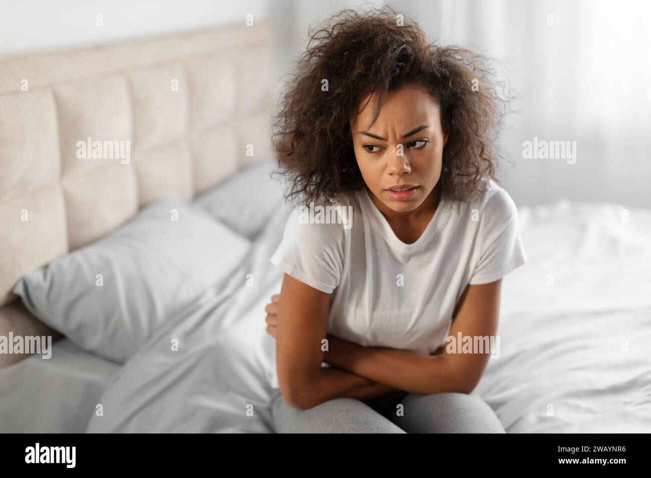 African American Young Lady Hugging Herself Feeling Bad In Bedroom ...