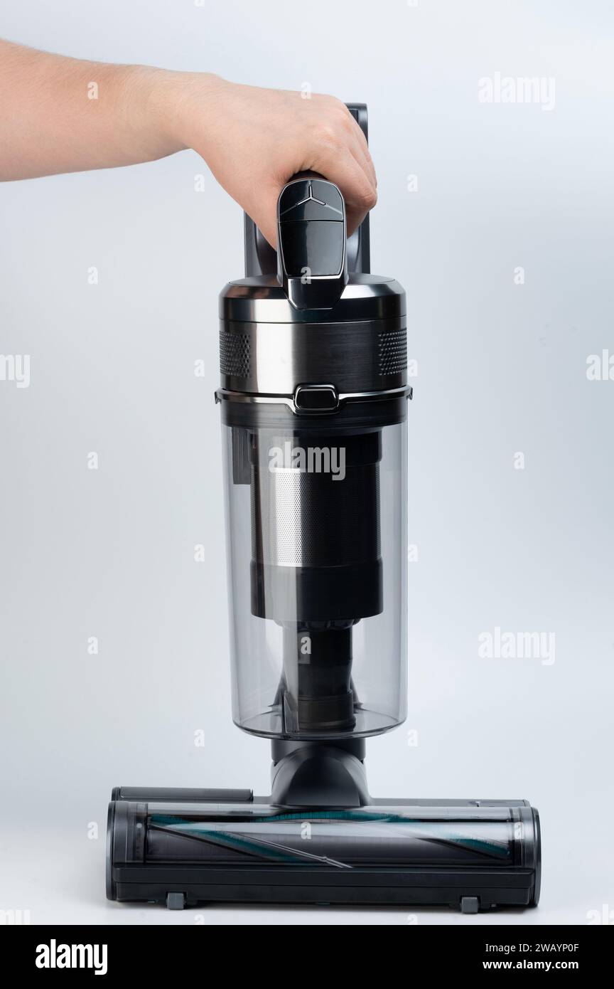 Close up of gray vacuum cleaner in hand isolated on white studio ...