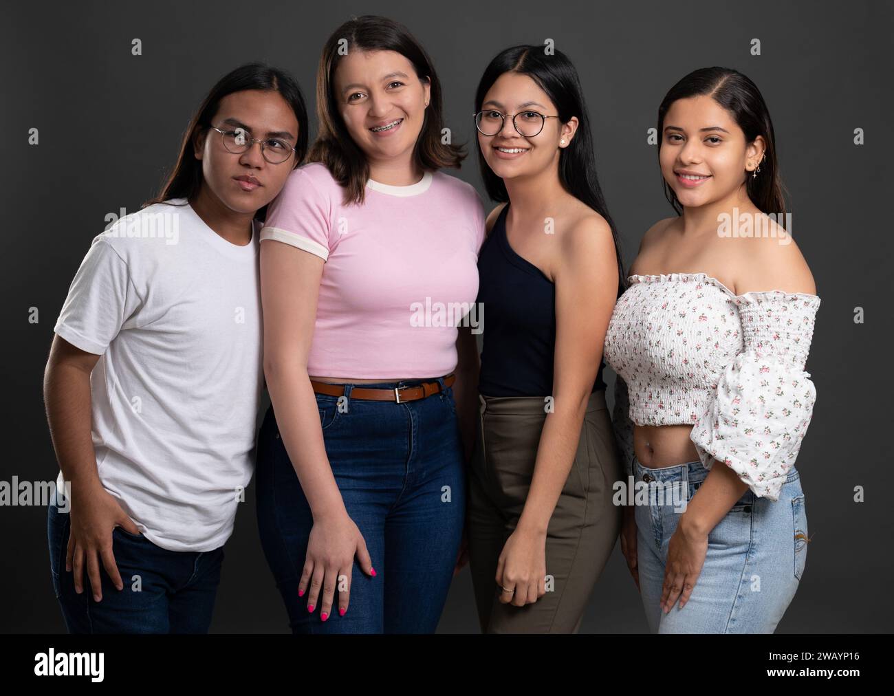 Four young positive hispanic people isolated on gray studio background ...