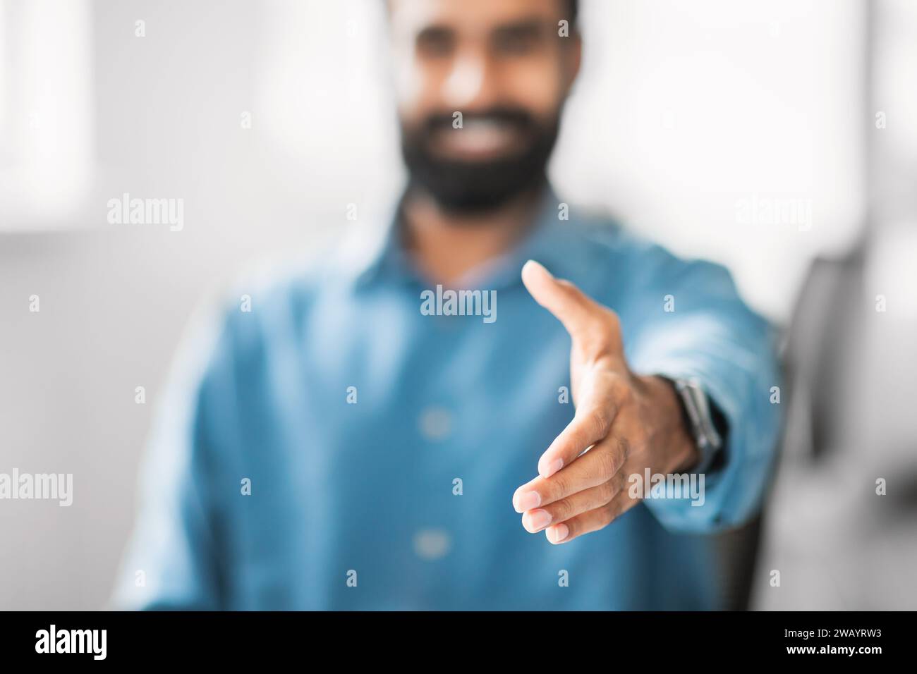 Indian businessman offering handshake in focus, welcoming gesture Stock ...