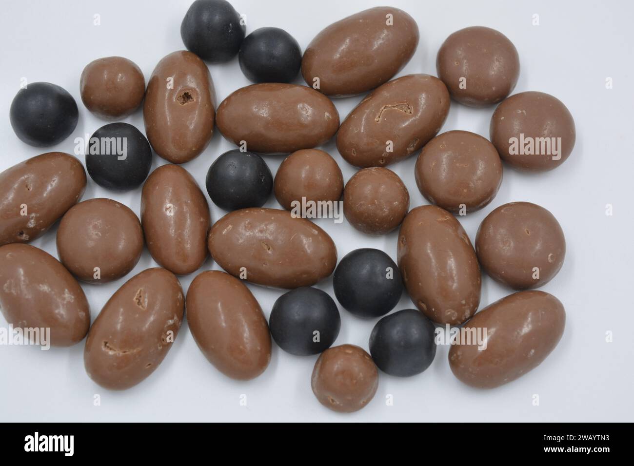 Chocolates of different sizes, peanuts, nuts, raisins are covered with ...