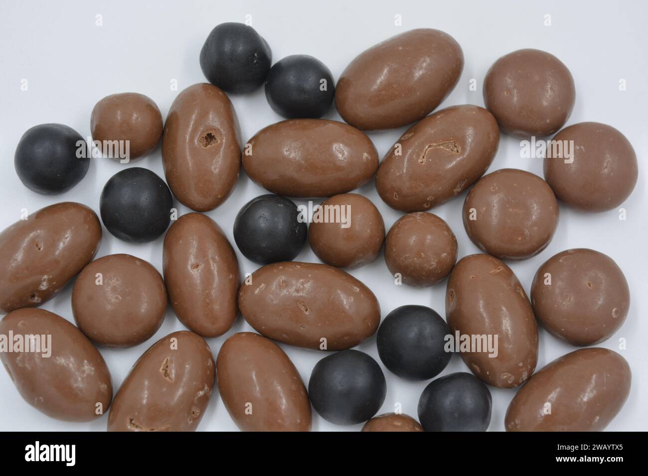 Chocolates of different sizes, peanuts, nuts, raisins are covered with ...