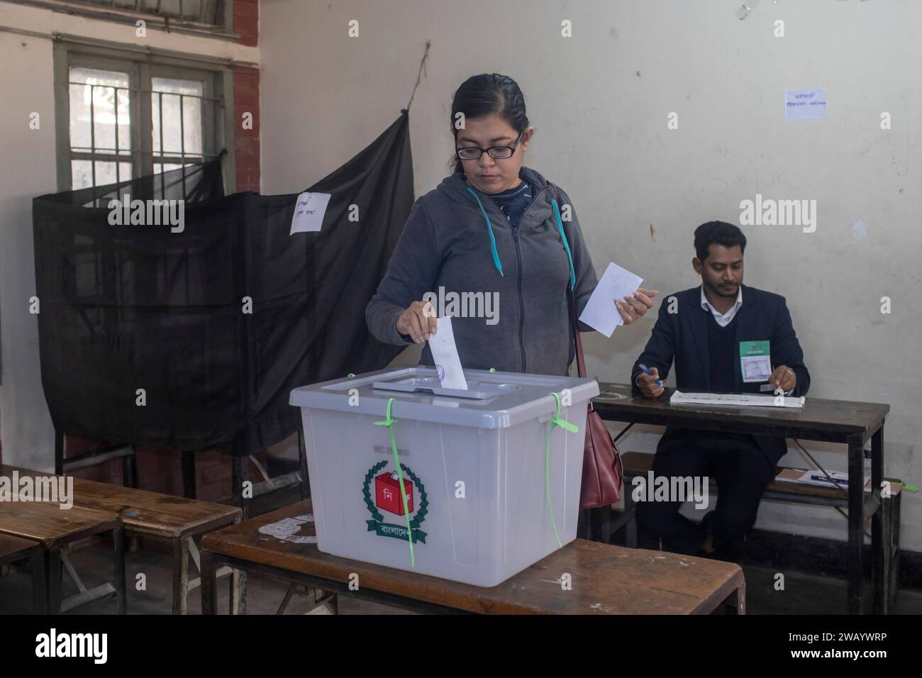 Dhaka, Bangladesh. 07th Jan, 2024. A woman casts her vote into a ballot ...