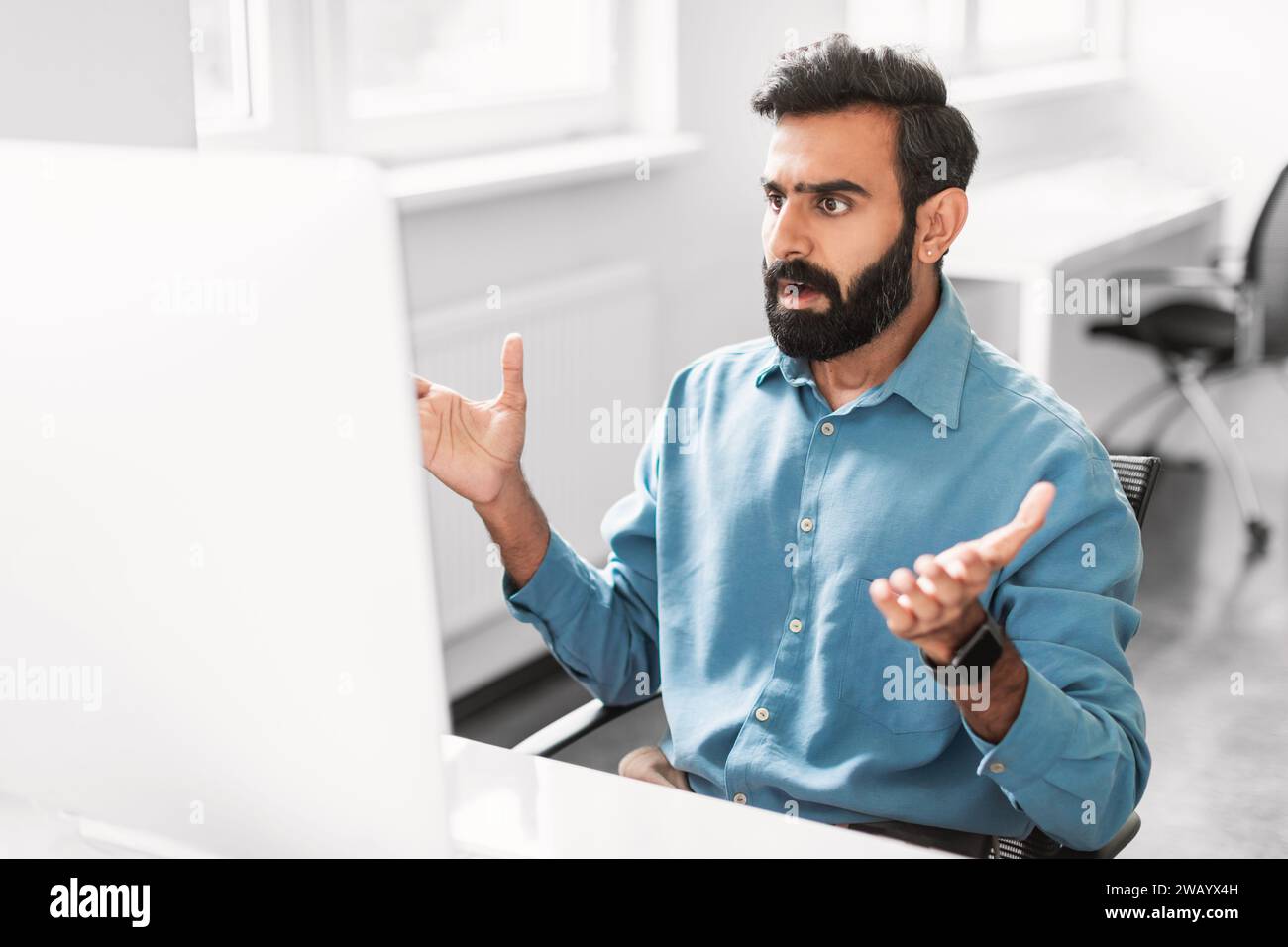 Surprised indian male office worker reacting to computer screen Stock Photo - Alamy