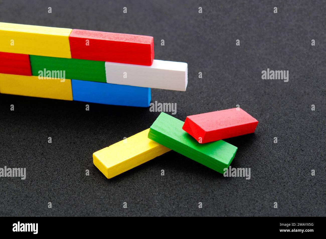 Three wooden slats of different colors ready to be placed next to the ...