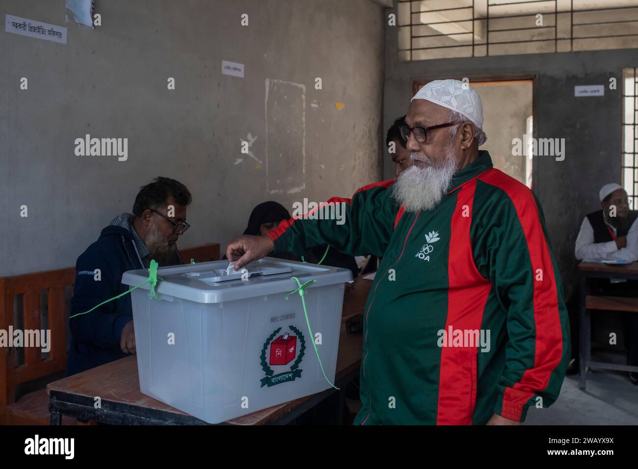 Dhaka, Bangladesh. 07th Jan, 2024. A man casts his vote into a ballot ...