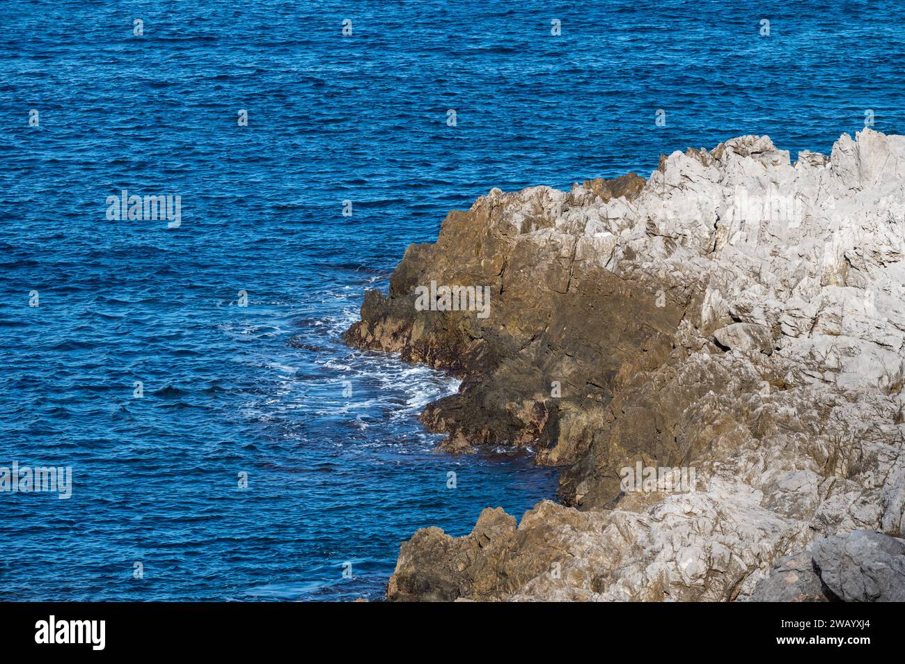 Blue water and rough rocks at Capo Gallo, Sicily, Italy Stock Photo - Alamy