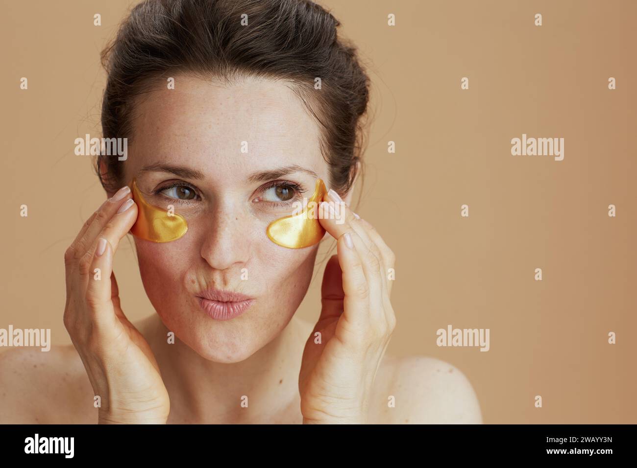 modern woman with eye patches isolated on beige background Stock Photo ...