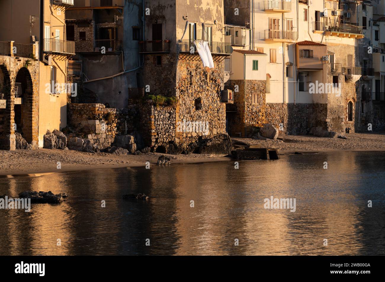 Houses at the old harbor during the golden hour in the village of ...