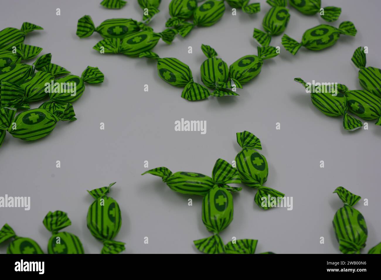 Bright, colorful factory menthol candies packed in green packaging with ...