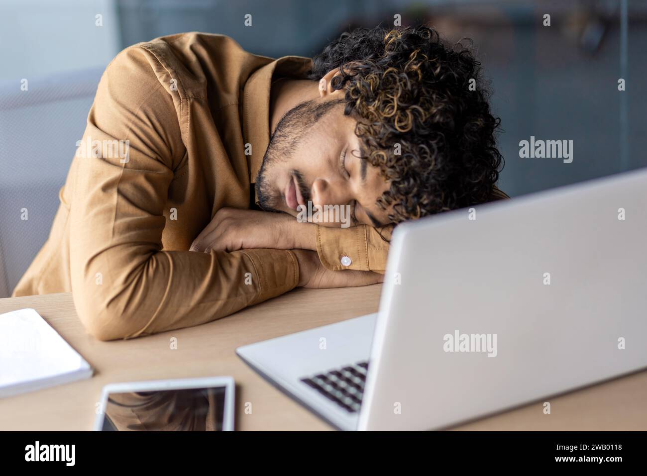 Businessman sleeping at workplace, young overtired and overworked man ...