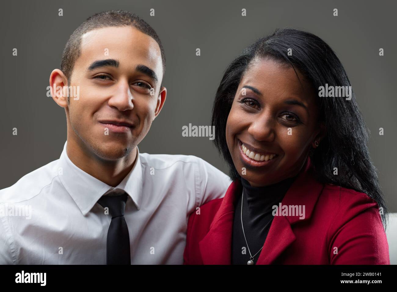 Professional duo in formal attire share a moment of joy, the contrast ...