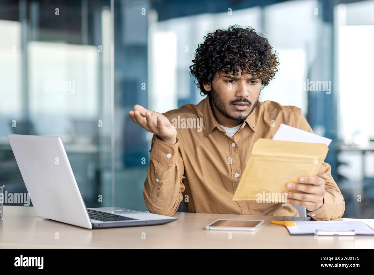 Sad unsatisfied and unhappy business man inside office at workplace ...
