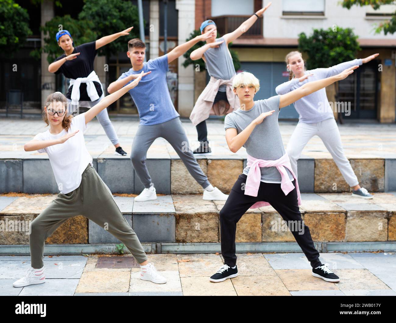 Teen boys and girls dancing modern choreography on city street Stock ...