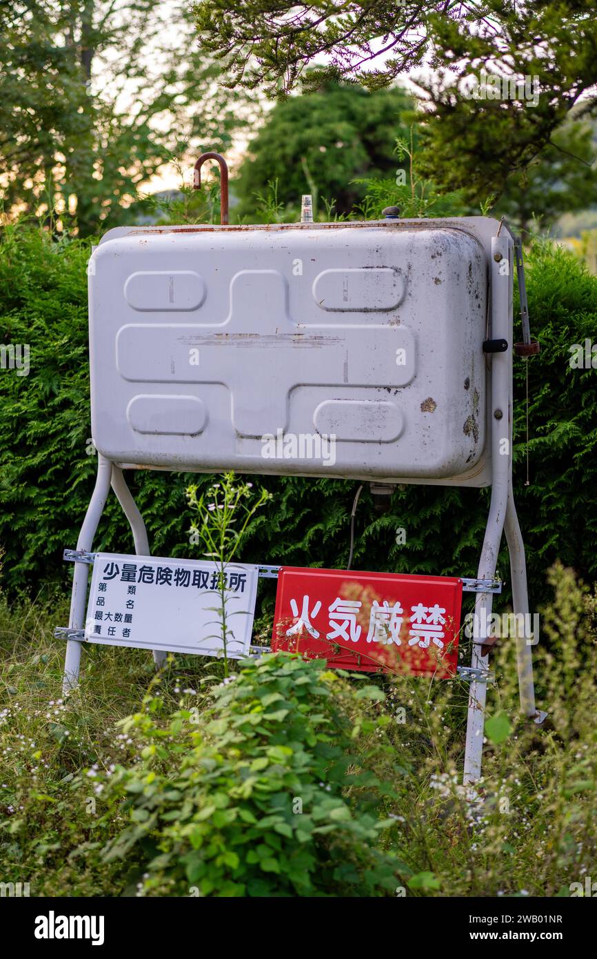 water tank for fire fighting sitting in a field near a home in central ...