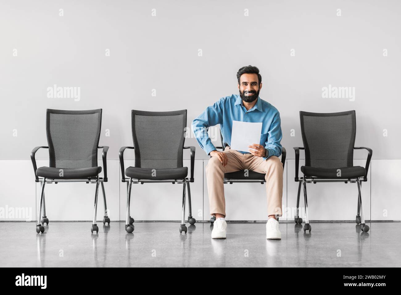 Young man sitting waiting hi-res stock photography and images - Alamy
