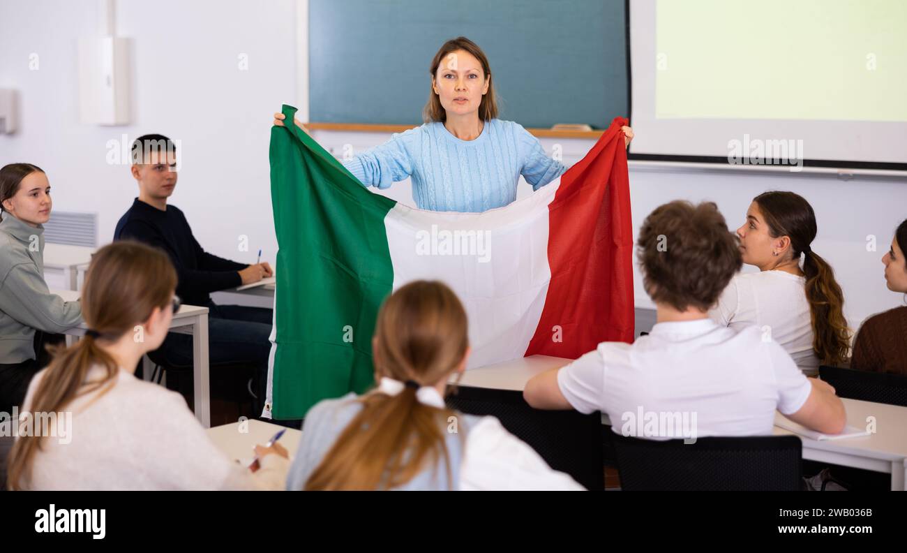 female professor shows students flag of Italy Stock Photo - Alamy