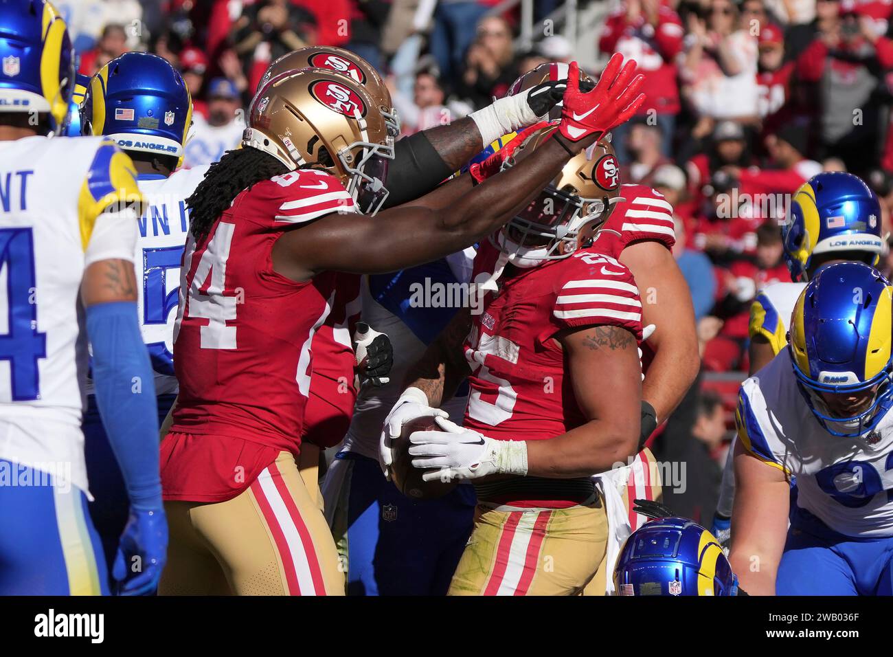 San Francisco 49ers running back Elijah Mitchell, middle right ...