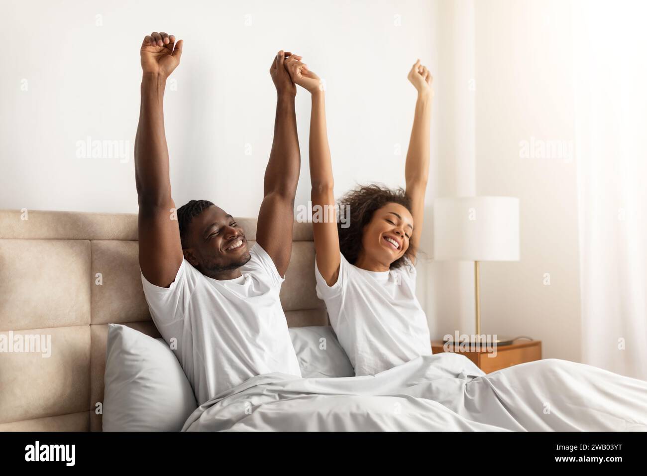 African american woman waking up stretching arms hi-res stock ...