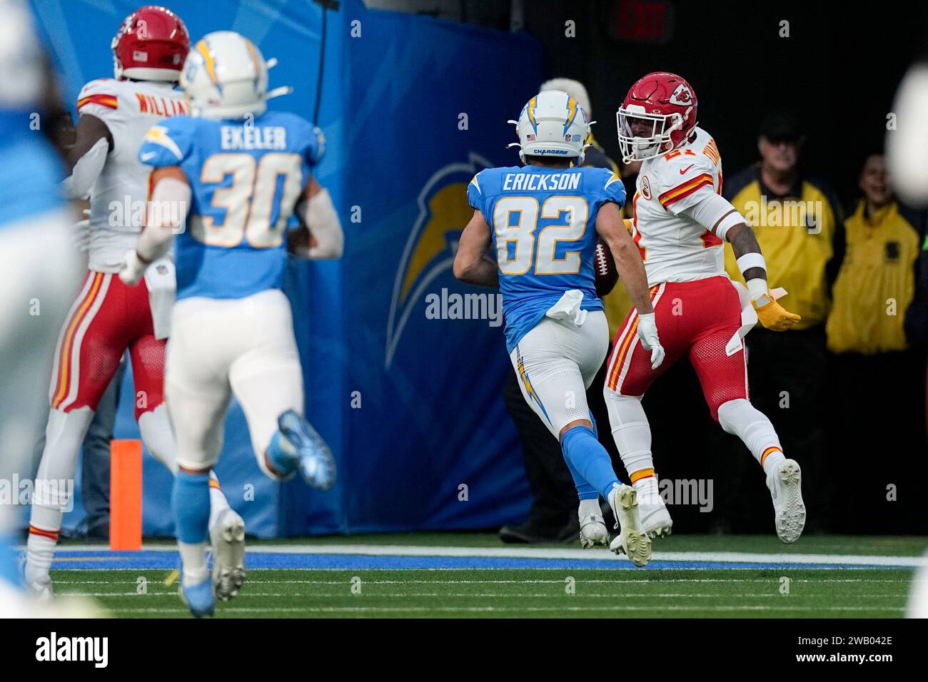 Kansas City Chiefs safety Mike Edwards, right, looks back as he runs ...