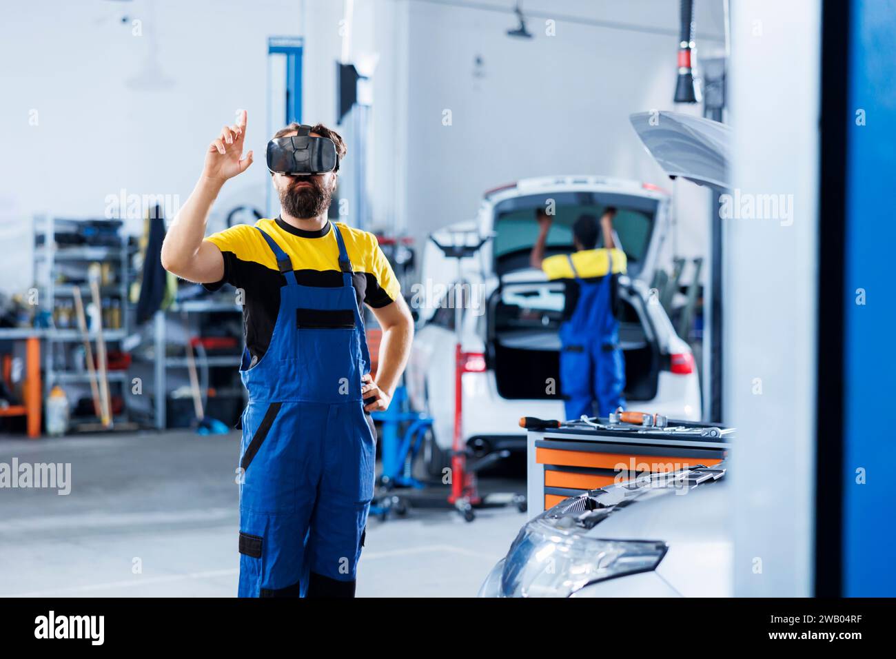 Mechanic in car service uses virtual reality to visualize steering ...