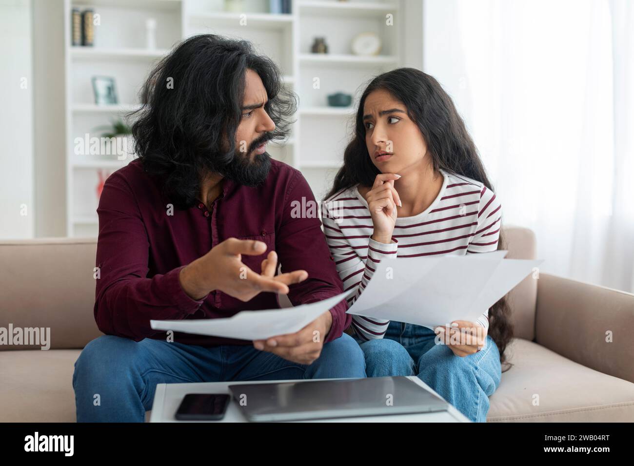 Budget Planning. Stressed Millennial Indian Spouses Holding Papers ...