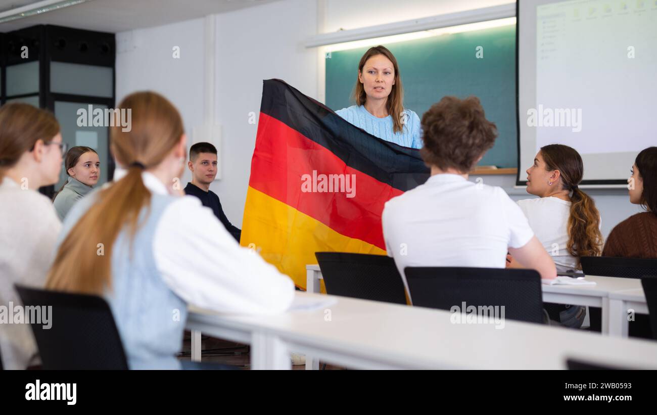 Female professor shows students flag of Germany Stock Photo - Alamy