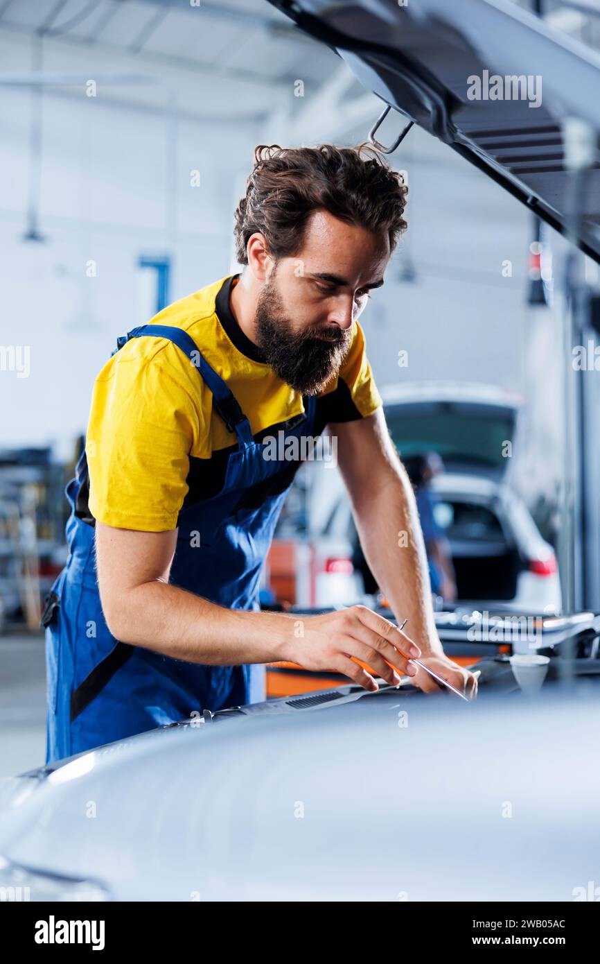 Engineer expertly examines fuel tank using advanced mechanical tools ...