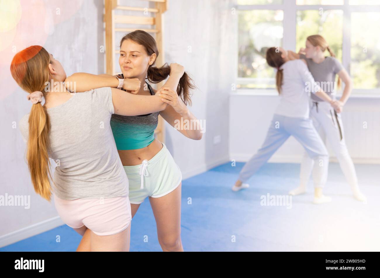 Teen girl practicing basic protection skills in training bout Stock ...