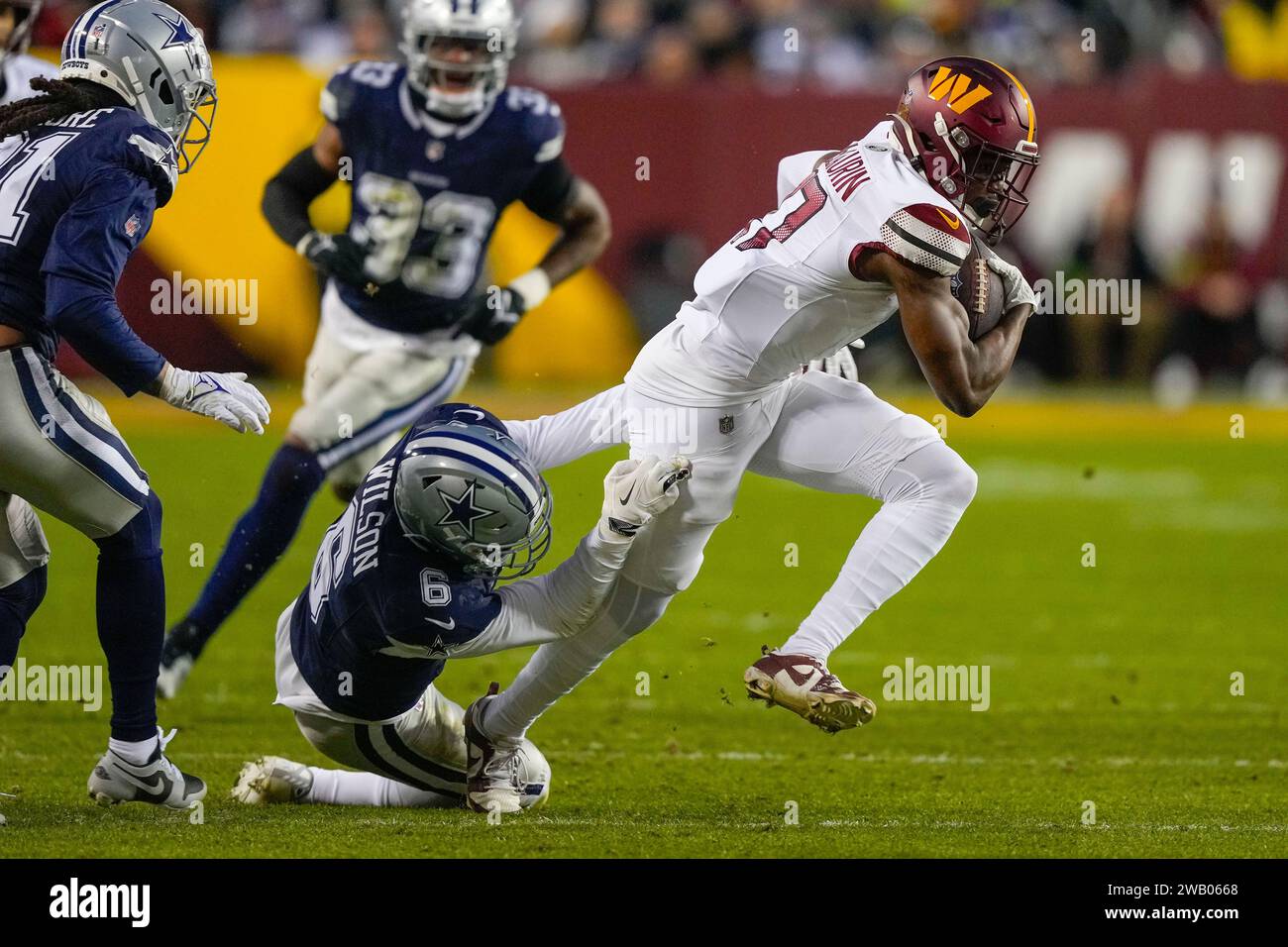 Dallas Cowboys safety Donovan Wilson (6) tackles Washington Commanders ...