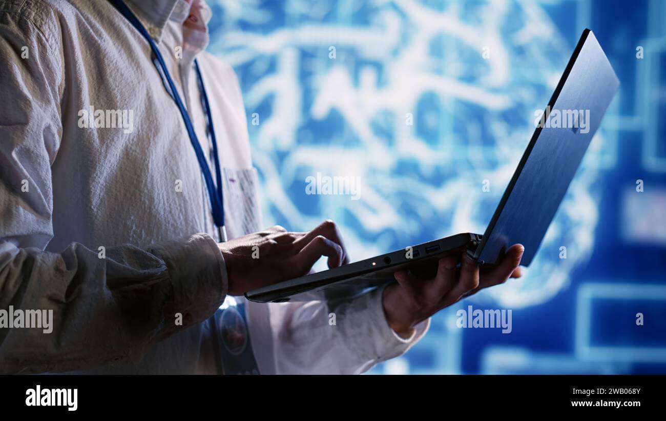 Knowledgeable executive using laptop to maintenance artificial intelligence neural networks made ...