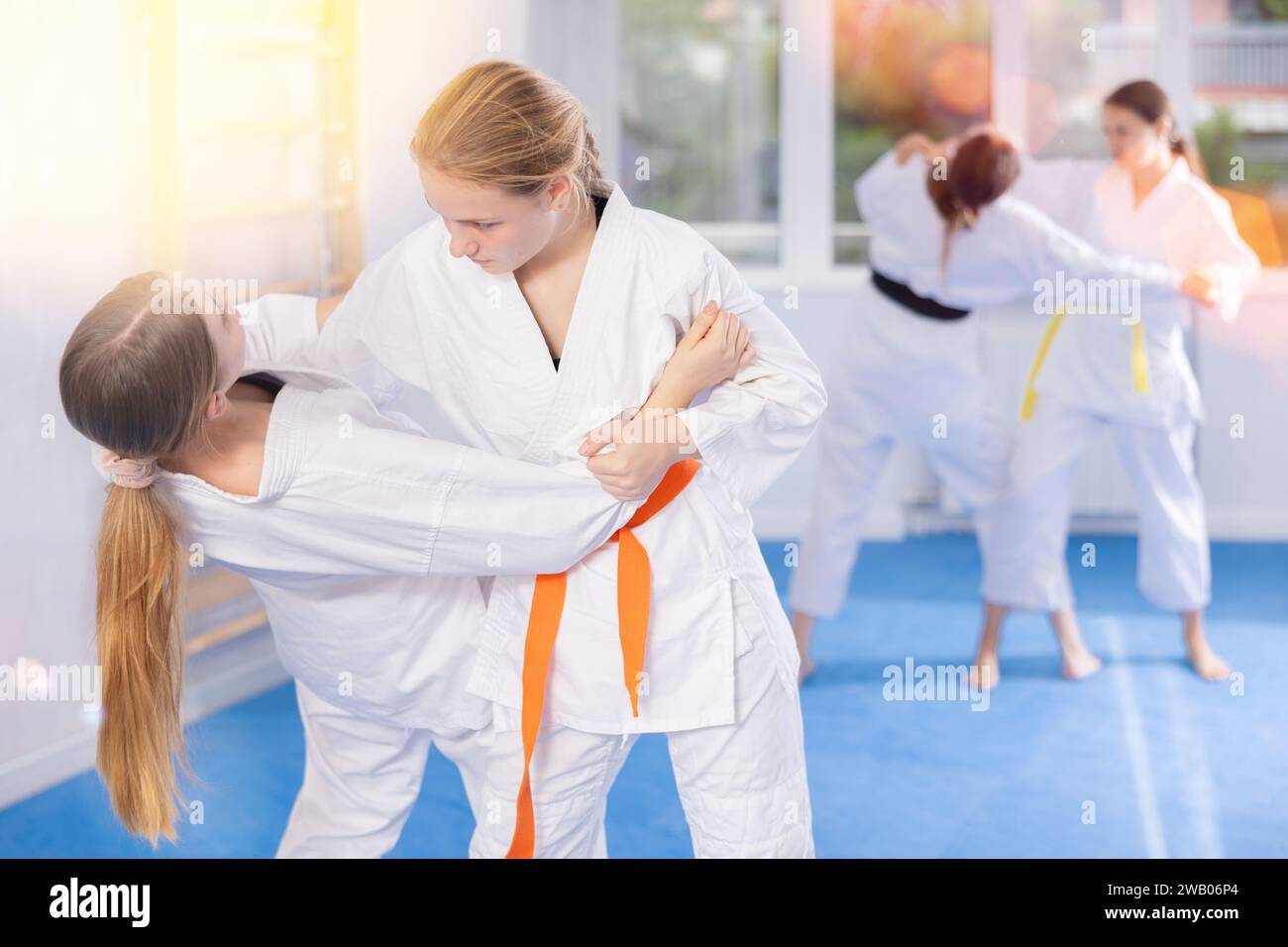 Female athletes in pair conduct training battle in oriental fighting ...