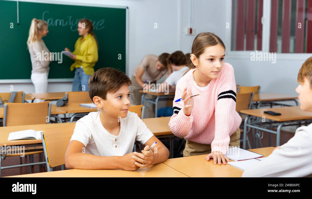 Fellow students having group work tasks during school class Stock Photo ...