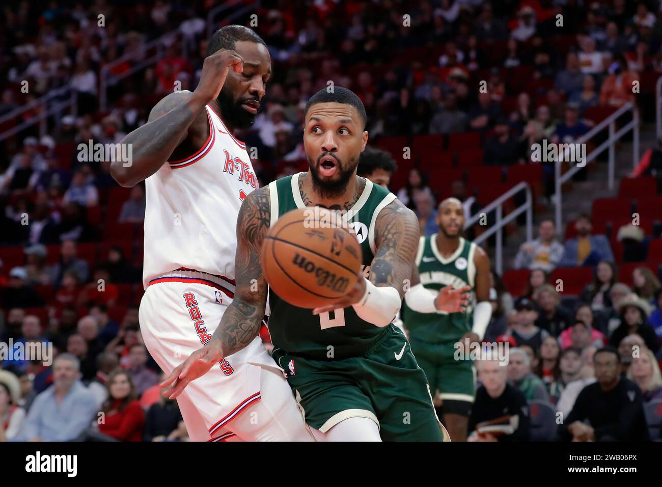 Milwaukee Bucks guard Damian Lillard, right, passes the ball around ...