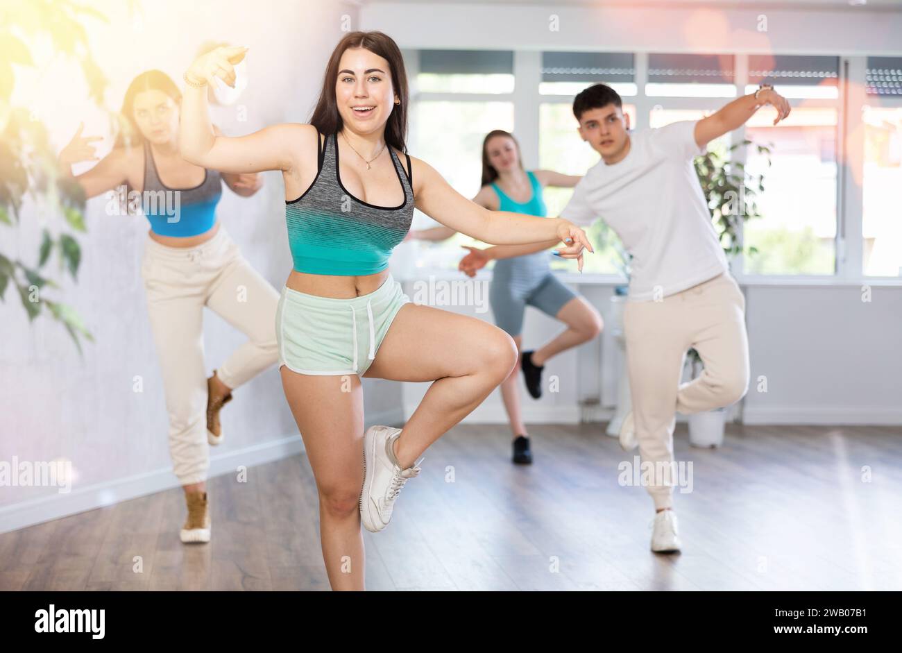 Group of young women and young guy dancing modern dances Stock Photo ...