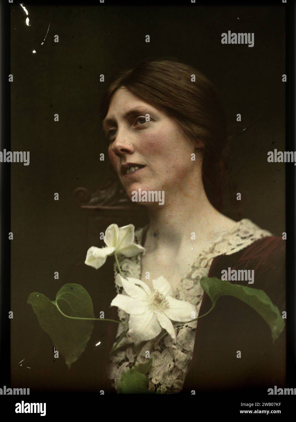 Portrait of a woman dressed in a red dress with two white flowers for ...
