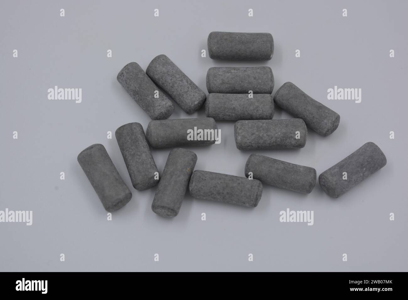 Unusual branded factory gummy candies in the form of gray, metal ...