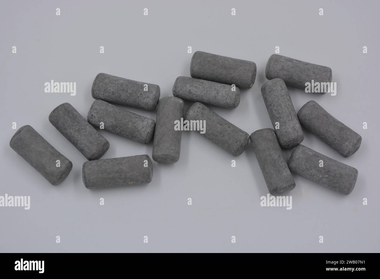 Unusual branded factory gummy candies in the form of gray, metal ...