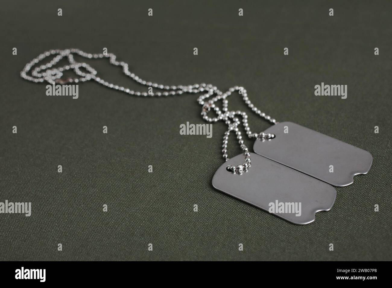 U.S. Army dog tags on olive drab uniform background Stock Photo - Alamy