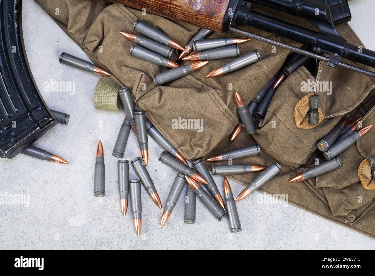 Kalashnikov ak gun and Chicom Chest Rig with 7,62 mm cartridges on grey ...