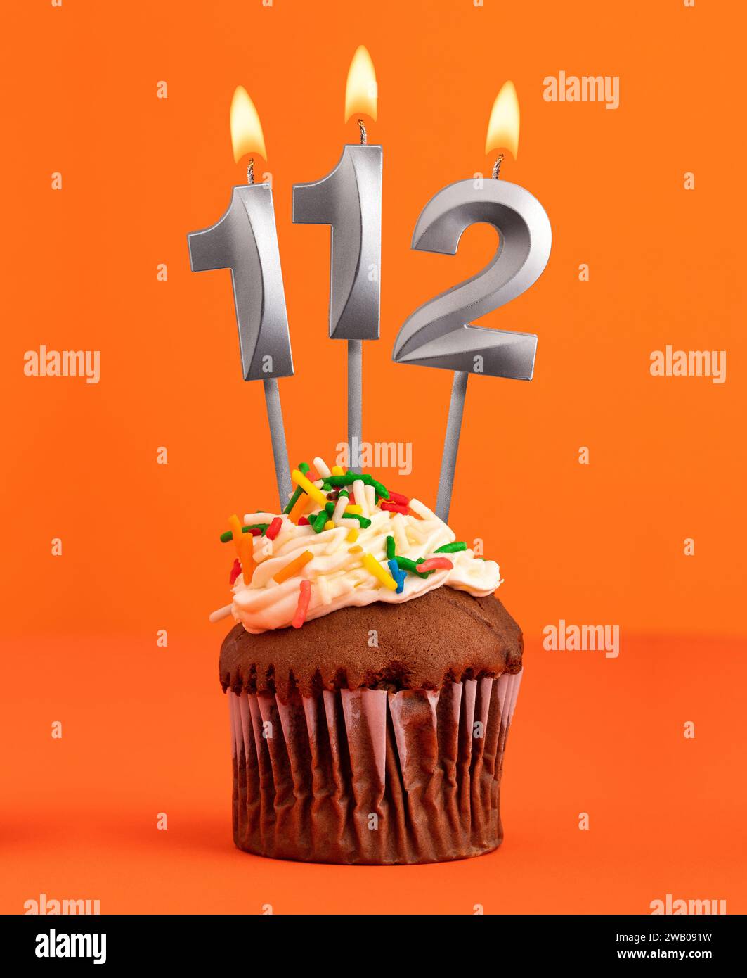 Birthday cupcake with number 112 candle - Orange color background Stock ...