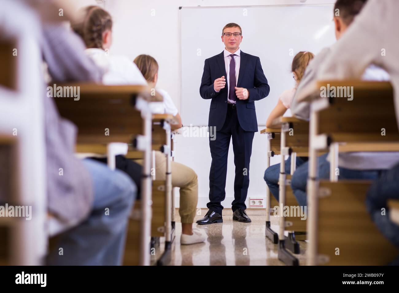 Male teacher lecturing to students at classroom Stock Photo - Alamy