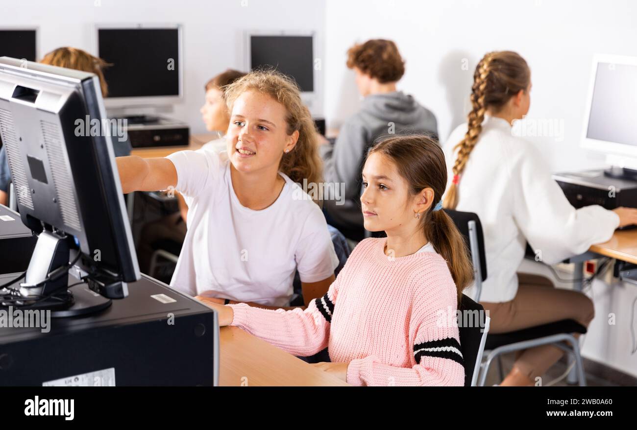 Young boys and girls using computers in classroom Stock Photo - Alamy