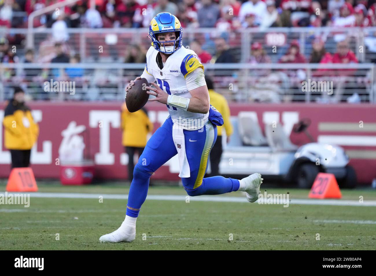 Los Angeles Rams quarterback Carson Wentz (11) rolls out to pass ...