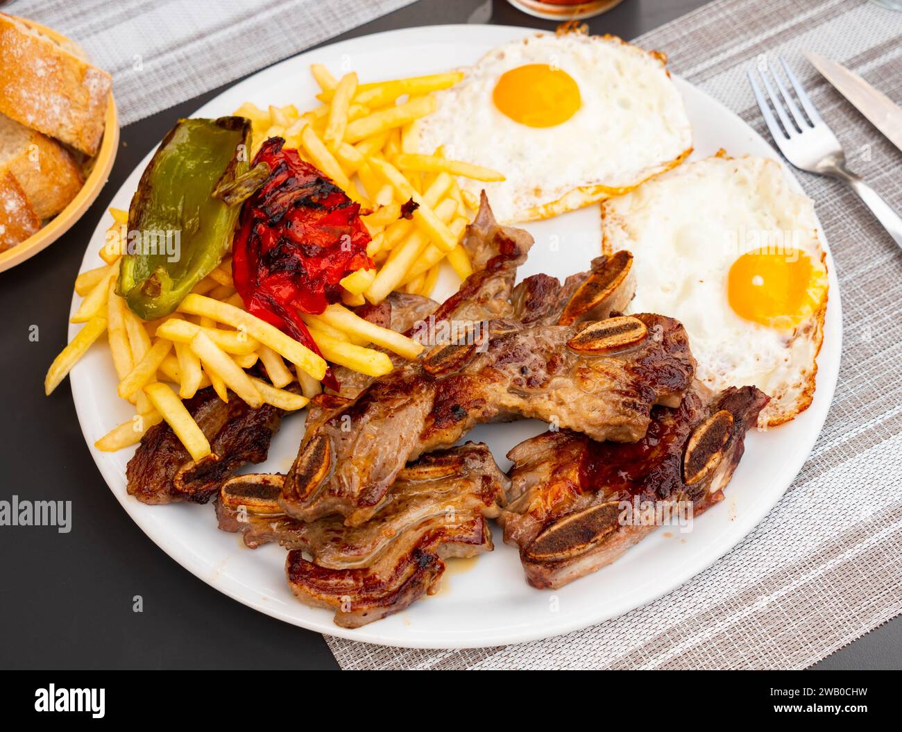 Combination meal with churrasco, fried eggs, french fries and peppers ...